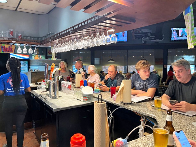The bar area's granite counter and overhead glass rack say "sit a spell and enjoy yourself."