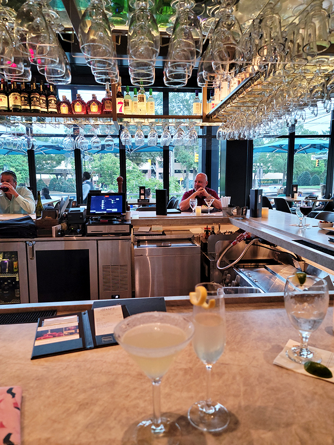 The bar at Perry's doesn't just serve drinks&mdash;it showcases liquid architecture. Glasses hanging like crystal stalactites above premium spirits.