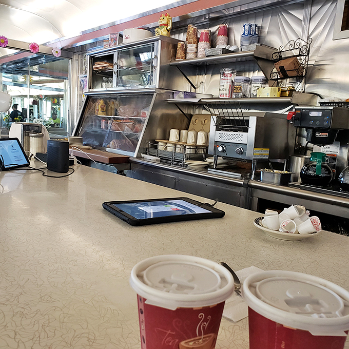 The counter where magic happens&mdash;stainless steel, perfectly arranged mugs, and the promise of coffee that never runs dry.