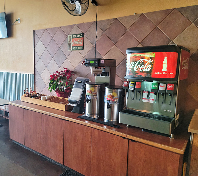 The beverage station stands ready for service, with those classic red Coca-Cola dispensers that somehow make every sip taste better.