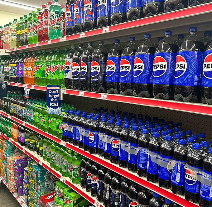 The beverage aisle: a colorful river of hydration options where Pepsi's blue brilliance dominates the landscape of affordable refreshment.