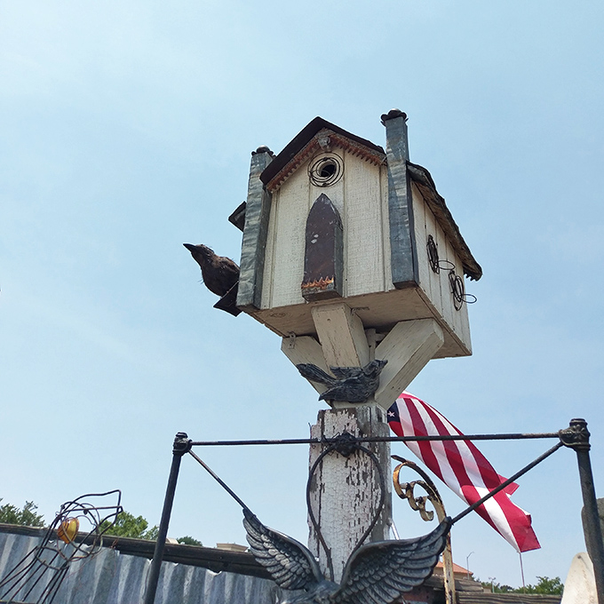 This whimsical birdhouse perched high above seems more like a fairy tale cottage than avian real estate.