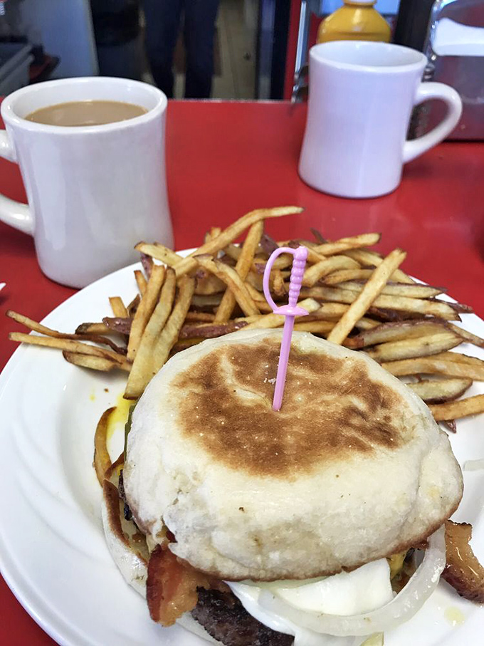 The humble breakfast sandwich elevated to art form&mdash;crispy-edged English muffin embracing eggs and meat in a handheld symphony of morning flavors.