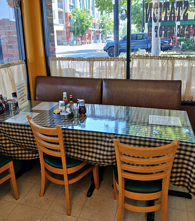 Booth seating with blue checkered tablecloths &ndash; the kind of cozy corner where family traditions are born and breakfast memories are made.
