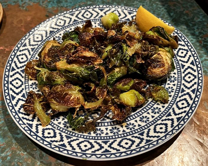 Brussels sprouts so perfectly caramelized they could convert even the most dedicated vegetable skeptics. Childhood redemption on a patterned plate.