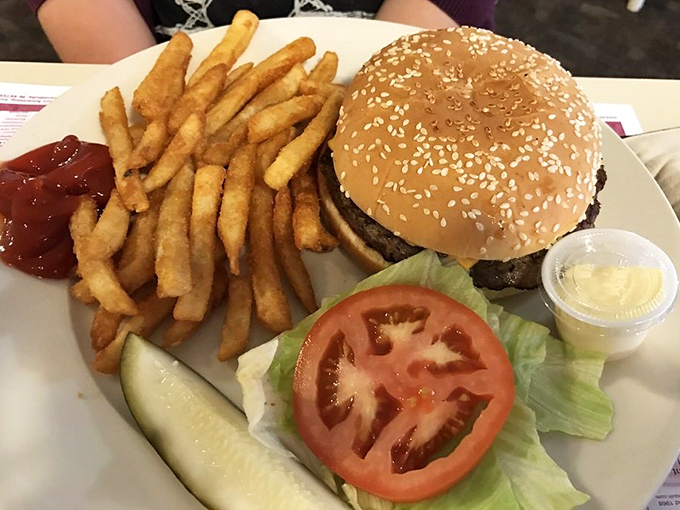 The classic American burger in its natural habitat&mdash;accompanied by crisp fries, a pickle spear, and the promise of satisfaction.