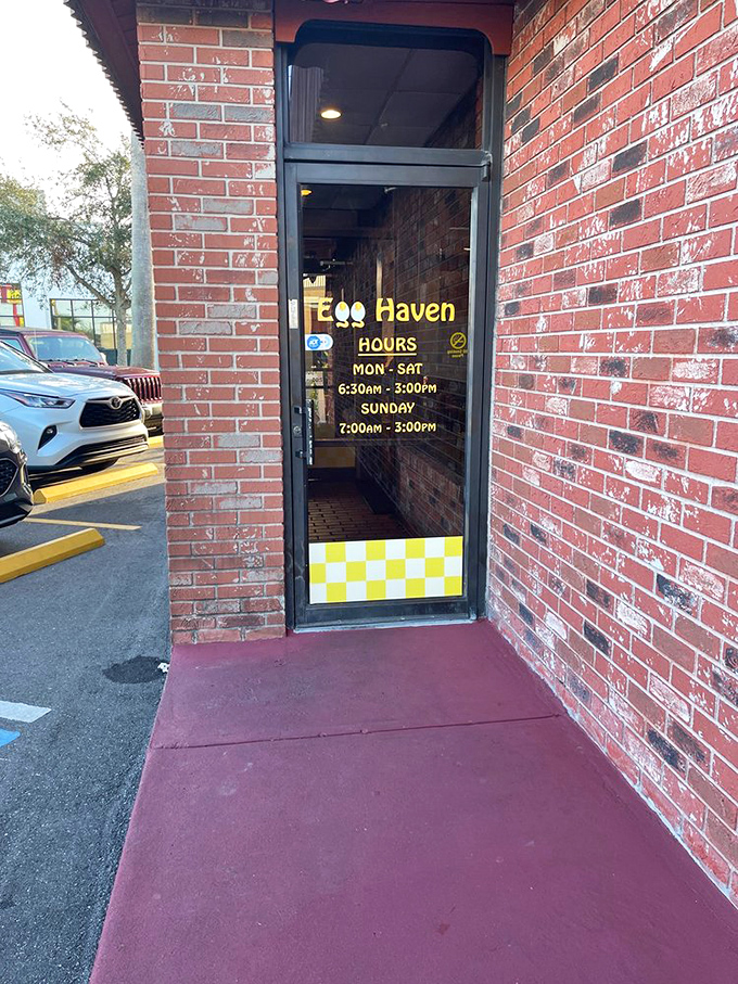 The entrance tells you everything you need to know: yellow-and-white checkerboard pattern, early hours, and a promise of eggs-cellent dining.