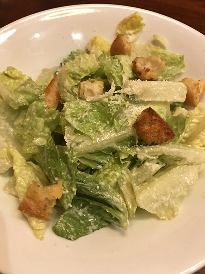 A Caesar salad that actually tries&mdash;crisp romaine, proper dressing, and croutons that weren't born in a factory three months ago.