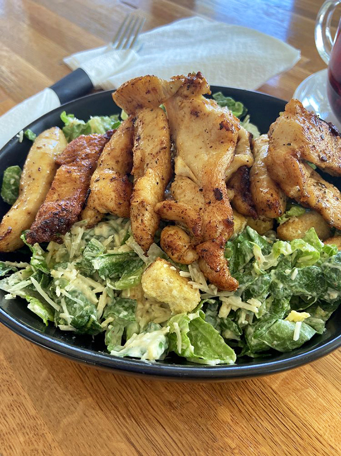 A Caesar salad that didn't skip protein day at the gym. Those seasoned chicken strips are ready to pump up your lunch experience.