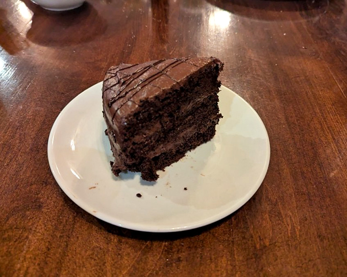 A slice of cake that understands the importance of dramatic entrances – towering layers that make you wonder if you should applaud before eating.