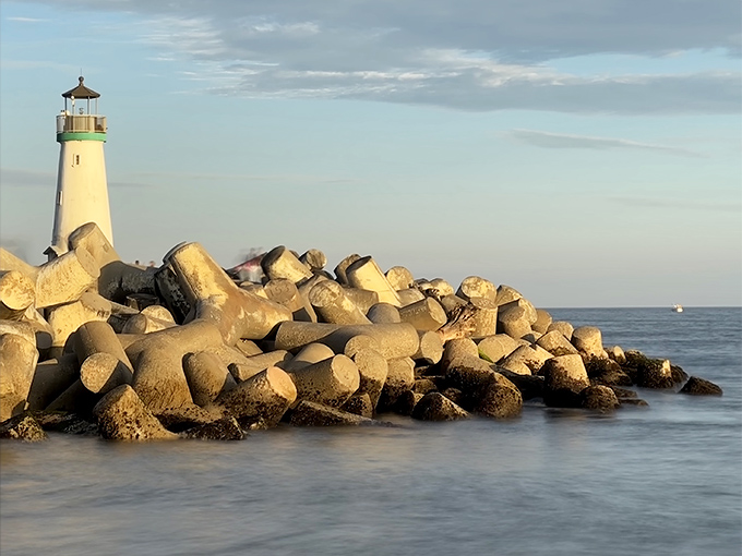Golden hour bathes the rocky breakwater in warm light, transforming ordinary concrete and stone into a photographer's dream landscape.
