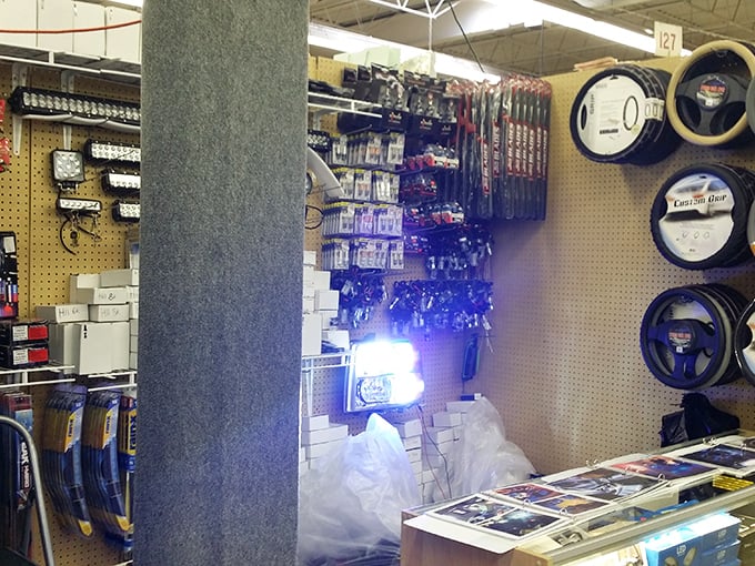 Steering wheels and automotive accessories hang like trophies on pegboard walls, promising to transform ordinary vehicles into personalized chariots.