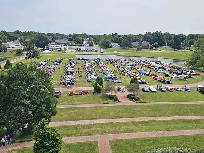 From this aerial view, the castle grounds become the perfect venue for community gatherings, where classic cars meet classic architecture.