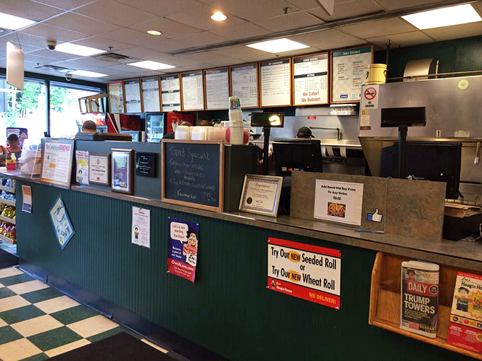 Behind the counter, menu boards promise everything from seeded rolls to wheat options for the carb-conscious.