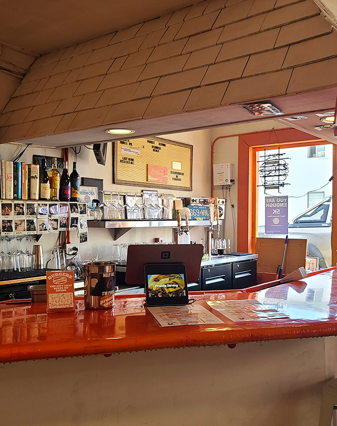 That gleaming orange counter isn't just functional&mdash;it's the stage where burger magic happens, complete with all the supporting characters.