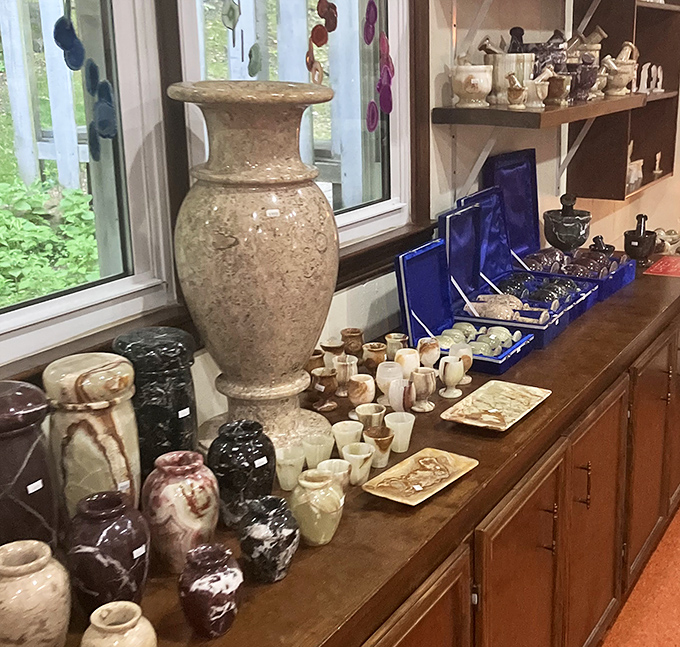 Handcrafted pottery and stone vessels line the shelves, inspired by the cavern's natural beauty and the region's artistic traditions.