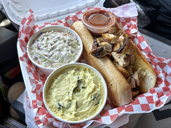 A proper chicken sandwich flanked by coleslaw and potato salad&mdash;the holy trinity of BBQ sides that turns a simple lunch into a celebration.