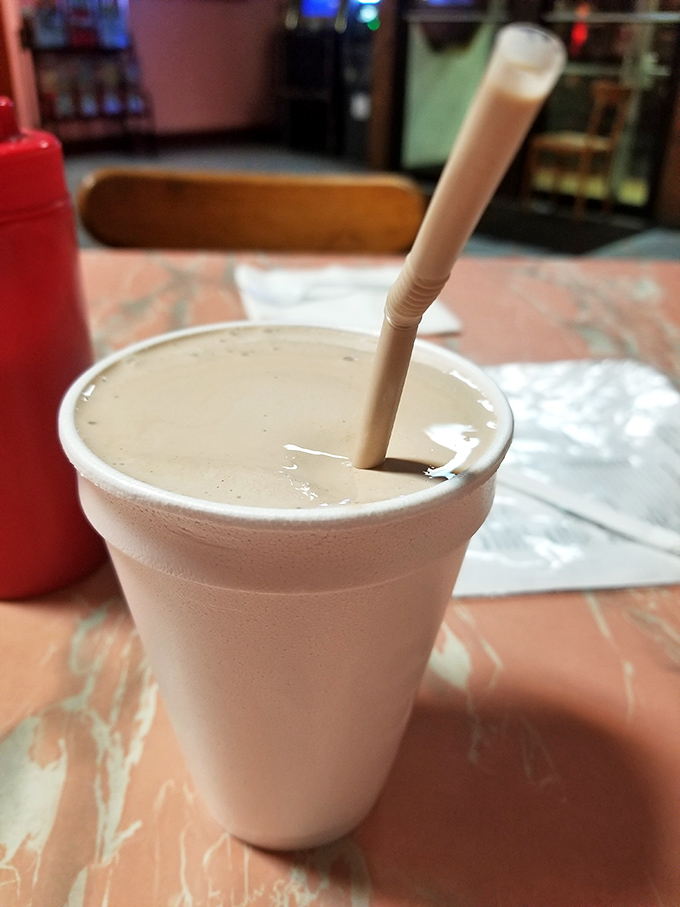 A chocolate malt in a styrofoam cup with a straw standing at attention&mdash;the kind of simple pleasure that makes you wonder why milkshakes ever needed to be "extreme."