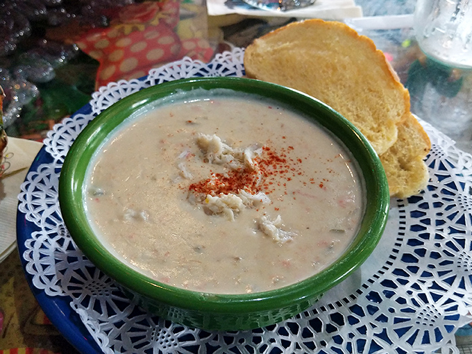 Their creamy clam chowder, served on a doily-lined plate with crusty bread, proves comfort food works even in tropical climates.