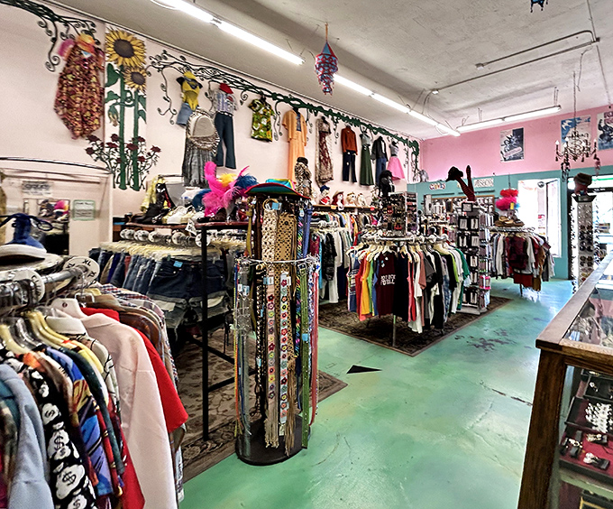 The green floor guides you through fashion history, while belts dangle like colorful snakes ready to cinch your next vintage find.