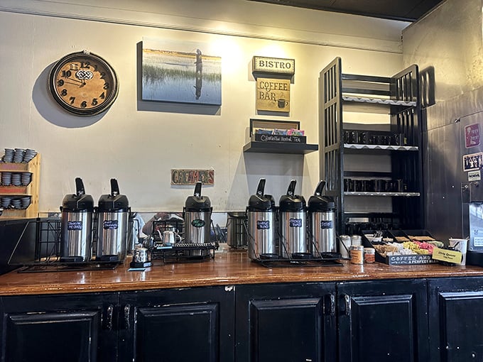 The coffee station stands ready for duty, thermal carafes lined up like soldiers in the breakfast battalion. This is command central for caffeine operations.