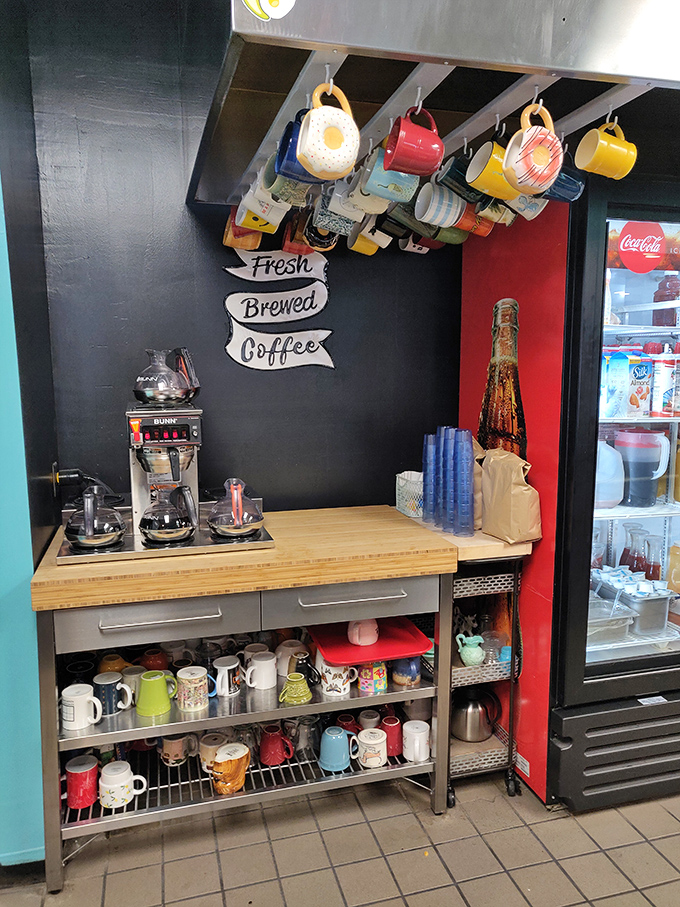 The coffee station&mdash;sacred ground where morning magic begins, with mugs hanging like trophies commemorating victories over early wake-up calls. 