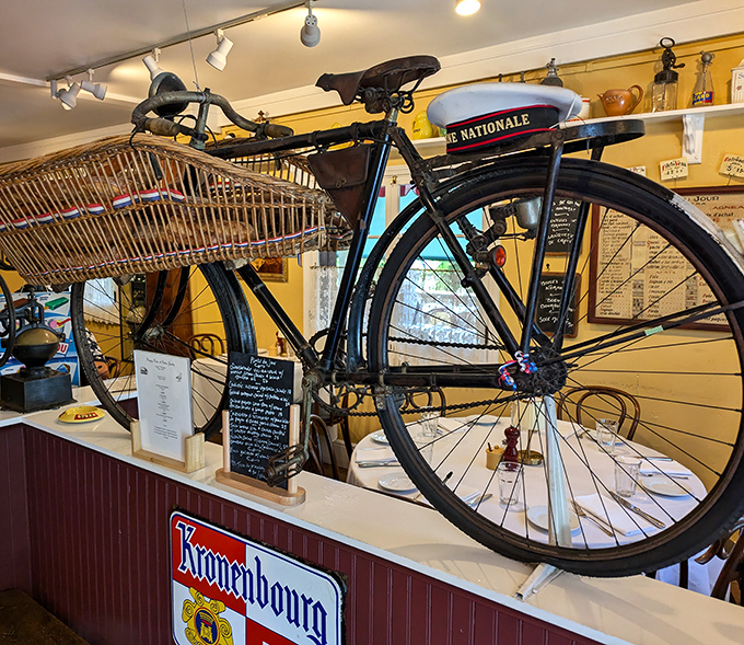 This vintage French bicycle isn't just decoration &ndash; it's a time machine to the streets of Paris, perfectly at home among the restaurant's authentic bistro atmosphere.