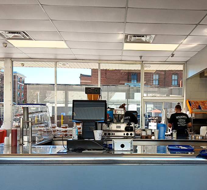 At the counter, culinary magic happens with practiced hands. This is food preparation as performance art.