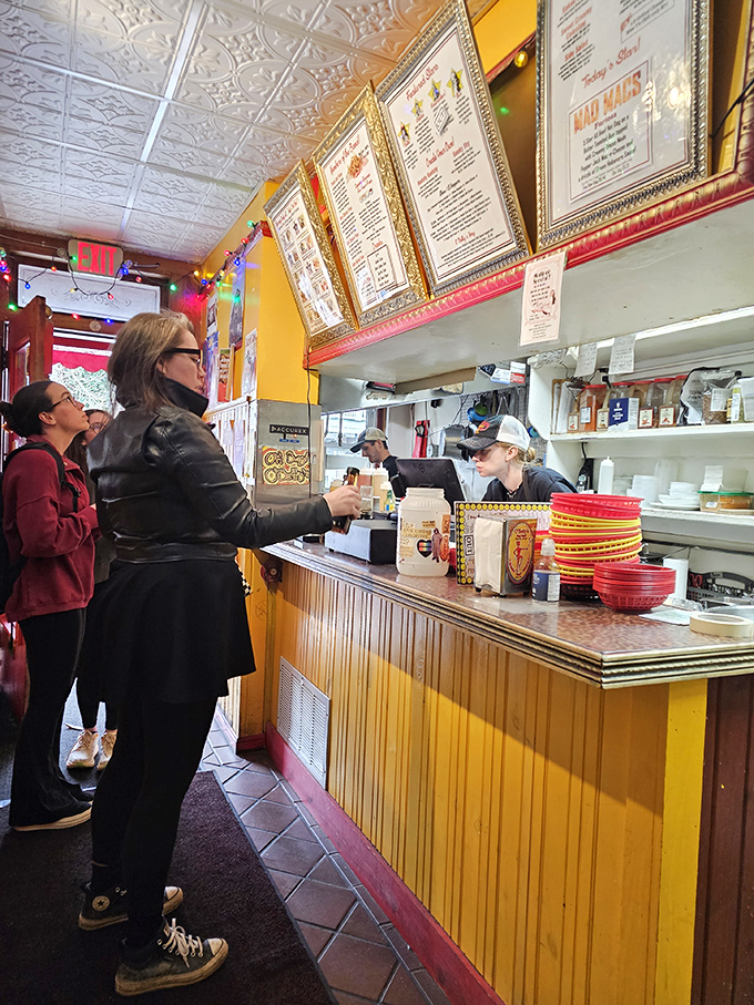 The ordering counter&mdash;where hot dog dreams come true. Those gold-framed menus aren't just decorative; they're treasure maps to flavor country.