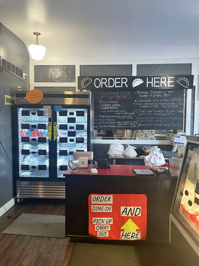 The ordering counter speaks volumes: handwritten menus, refrigerated treasures, and a straightforward system that says "we're about food, not fuss."