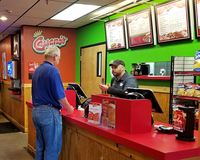 The counter where pizza dreams become reality – a simple transaction that locals have been completing for decades with delicious results.