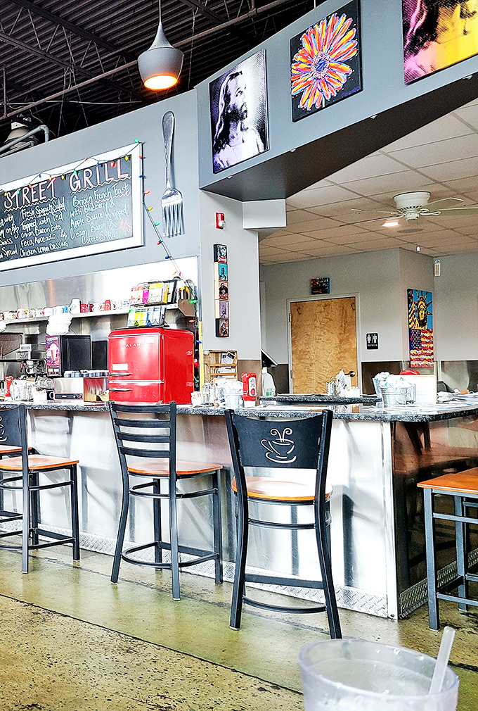 The counter seating area showcases local art and a vintage-style refrigerator &ndash; nostalgic touches that enhance the dining experience.