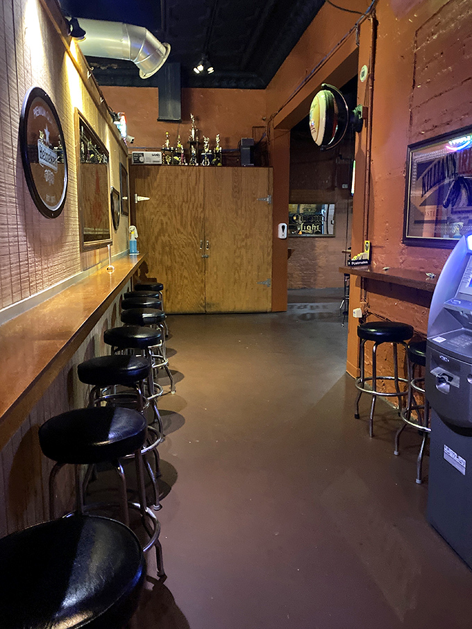 The narrow bar area offers intimate counter seating where regulars exchange stories and newcomers quickly become part of the Slammers family.