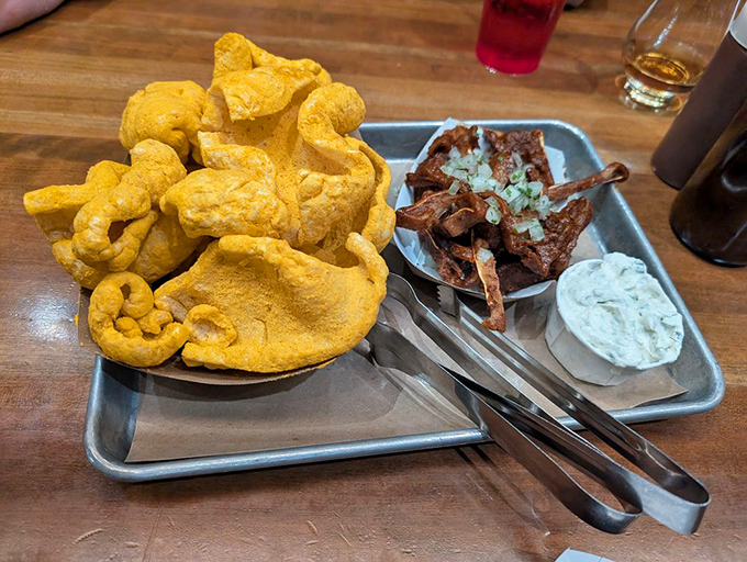 Cracklins that shatter like savory glass alongside pig ears that would make even the most dedicated vegetarian question their life choices.