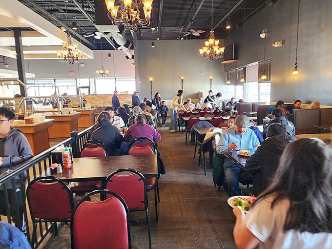 A dining room filled with the universal expression of buffet happiness&mdash;people focused intently on their plates, planning their next strategic move.