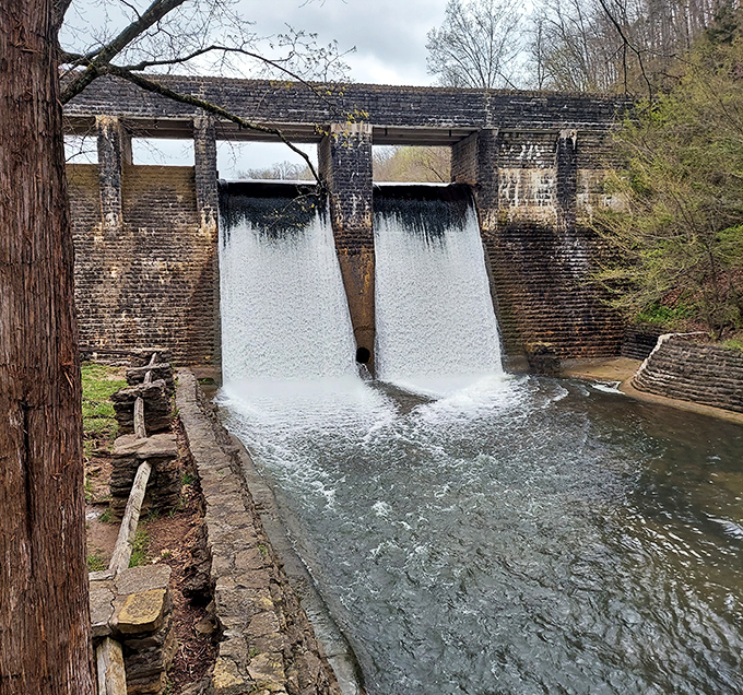 This historic dam transforms falling water into visual poetry, a reminder that sometimes the most impressive engineering works with nature, not against it.