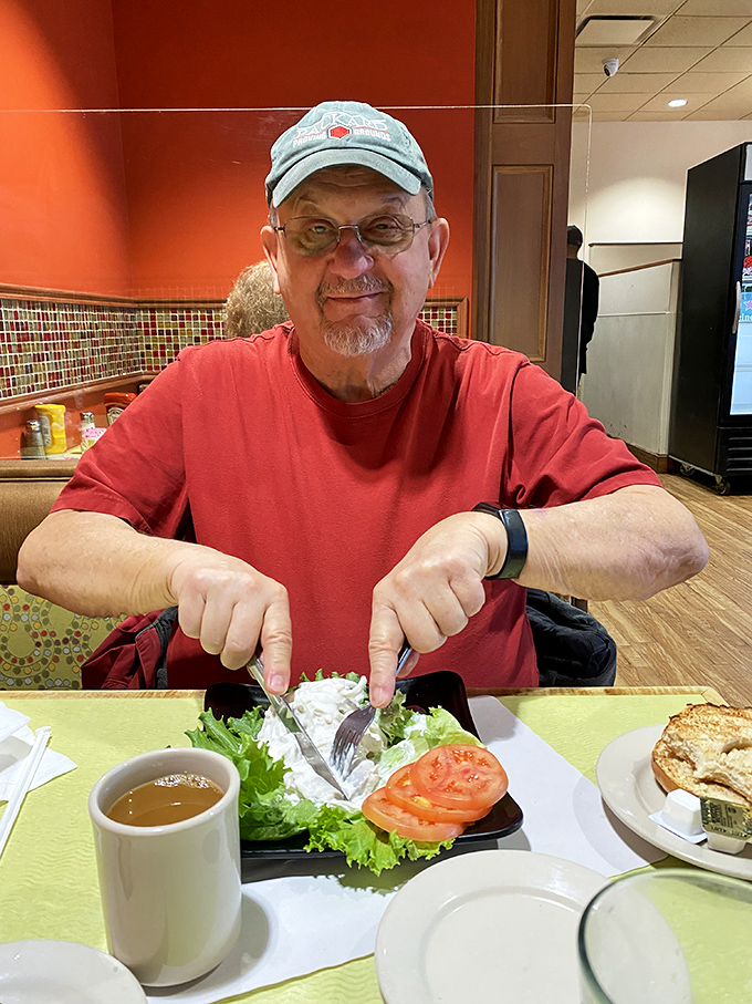 A happy diner points to his plate with the universal gesture that says, "This right here? This is what happiness tastes like."