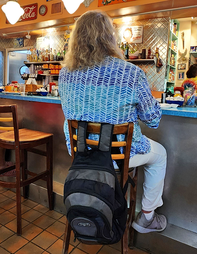 Where patrons with sun-bleached hair and island stories settle in at the bar, backpacks at their feet, ready for sustenance and local wisdom.