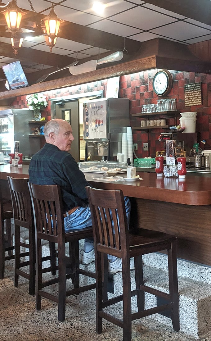 A patron enjoying the timeless ritual of counter dining&mdash;where you can watch your breakfast being born right before your eyes.