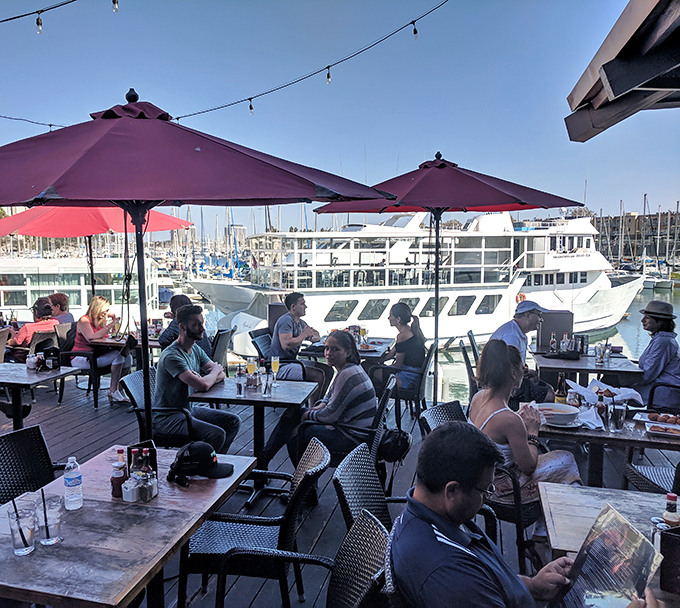 Diners bask under burgundy umbrellas, proving that vitamin sea and people-watching make the perfect accompaniments to any meal.