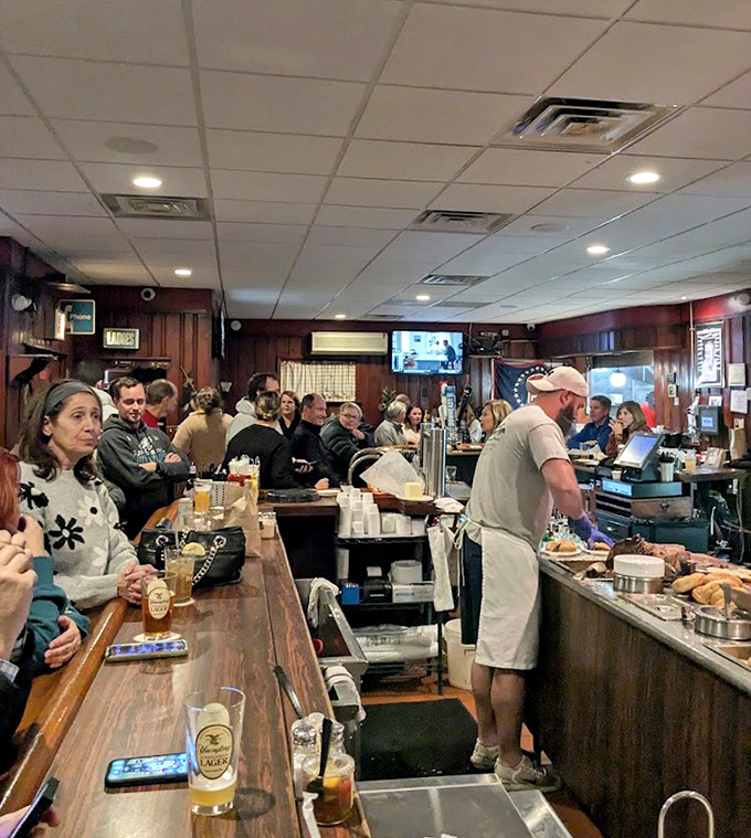 The true measure of a great tavern: happy people gathered at the bar, patiently waiting for food they know will be worth it.