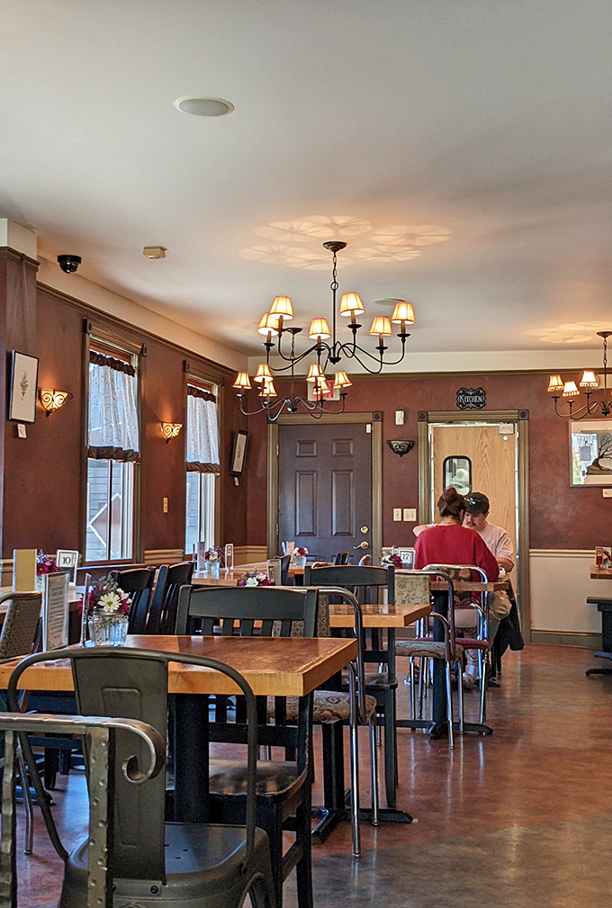 Warm walls, chandeliers, and mismatched chairs create that perfect "third place" between home and work where conversations flow as easily as the coffee. 