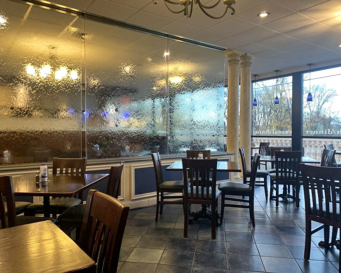 The dining room balances casual comfort with subtle elegance, where textured glass dividers create the illusion you've stepped into a taverna overlooking the Aegean.