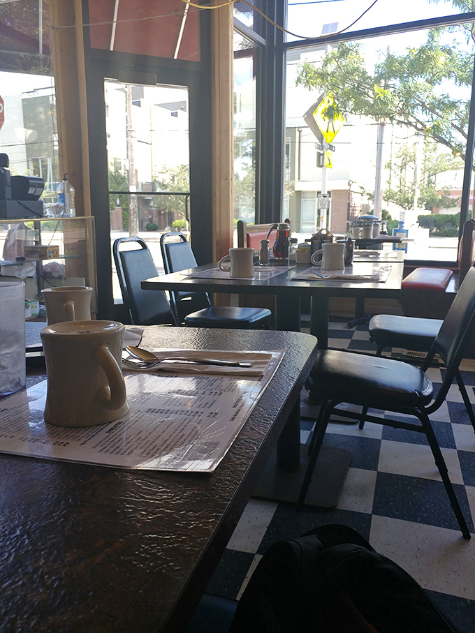 Morning light streaming through windows onto tables set for breakfast battles. The calm before the delicious storm.