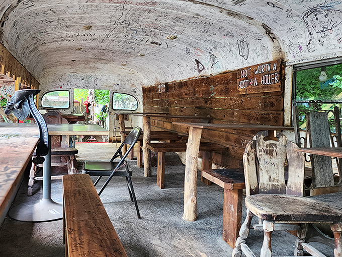 The school bus dining area&mdash;where eating hot dogs becomes an immersive experience. Those signatures on the ceiling? Each tells a story.