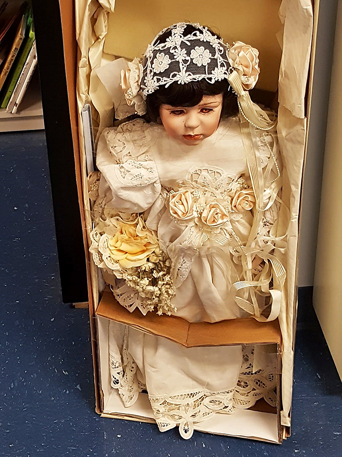 A vintage bride doll that's either a collector's dream or tonight's nightmare, depending entirely on your tolerance for porcelain faces staring into your soul.