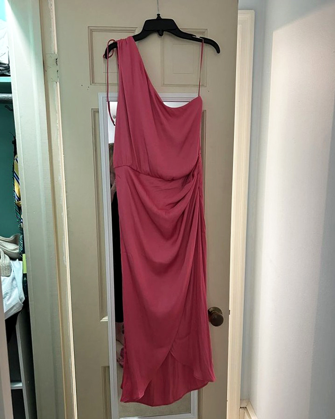 One-shoulder elegance hanging patiently for its next big event. This coral dress proves formal wear needn't be worn just once.