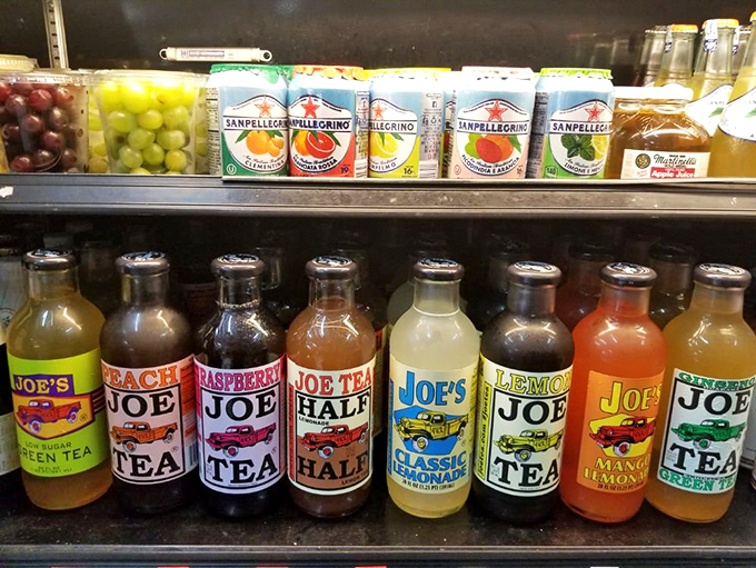 The drink cooler offers colorful Joe's Teas alongside San Pellegrino, proving that even beverage selection at Christie's is a carefully curated experience.