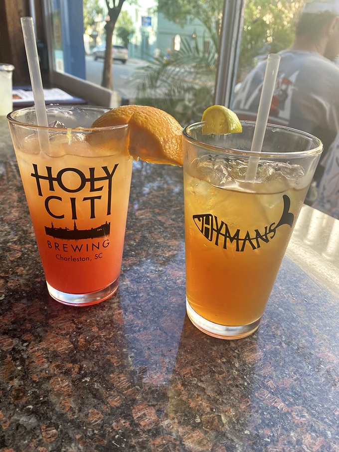 Two refreshing drinks with citrus garnishes&mdash;liquid sunshine in glasses that promise to cool you down after a day of Charleston exploration.