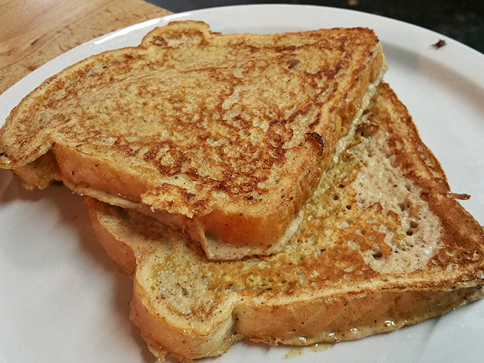 French toast with that perfect golden hue&mdash;crisp edges, tender center, and enough surface area to support a proper lake of syrup.